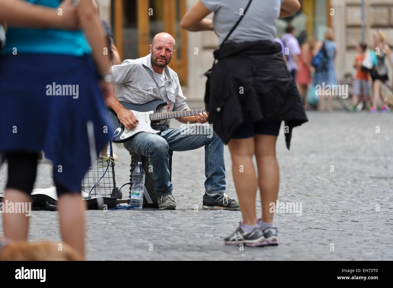 Male street performer playing guitar hi-res stock photography and ...