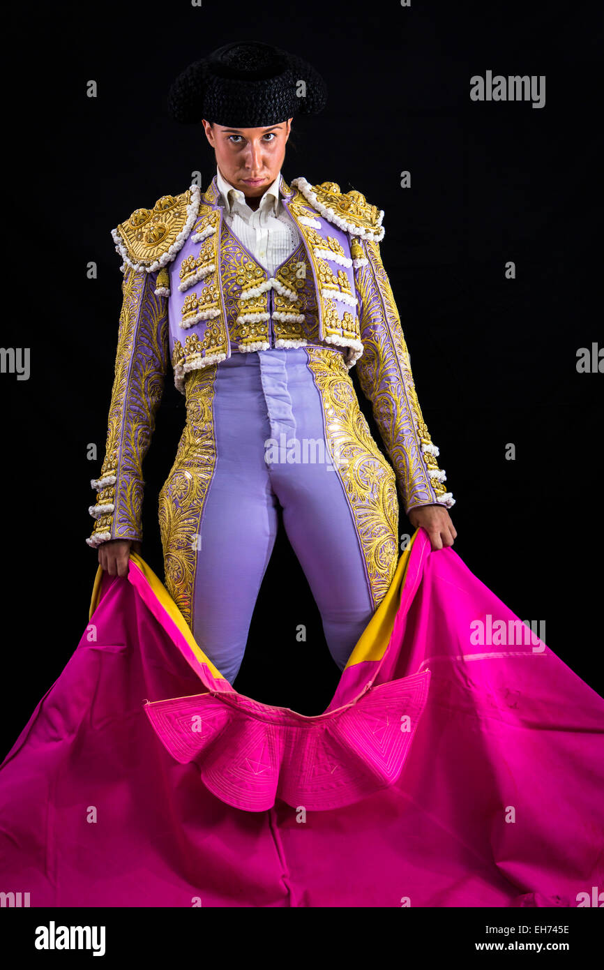 Woman bullfighter holding capote pink on black background Stock Photo ...