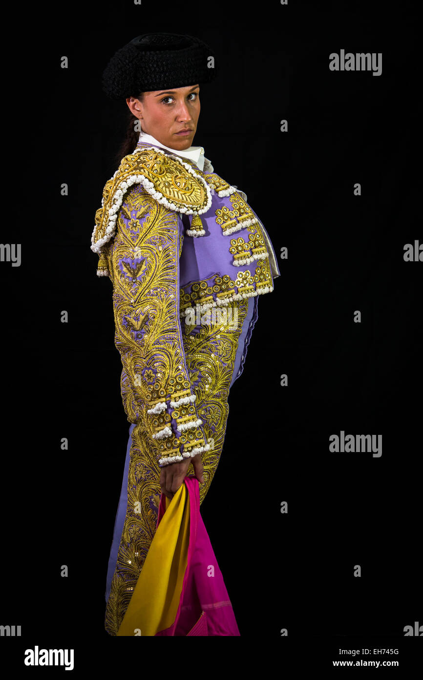 Woman bullfighter holding capote pink on black background Stock Photo ...