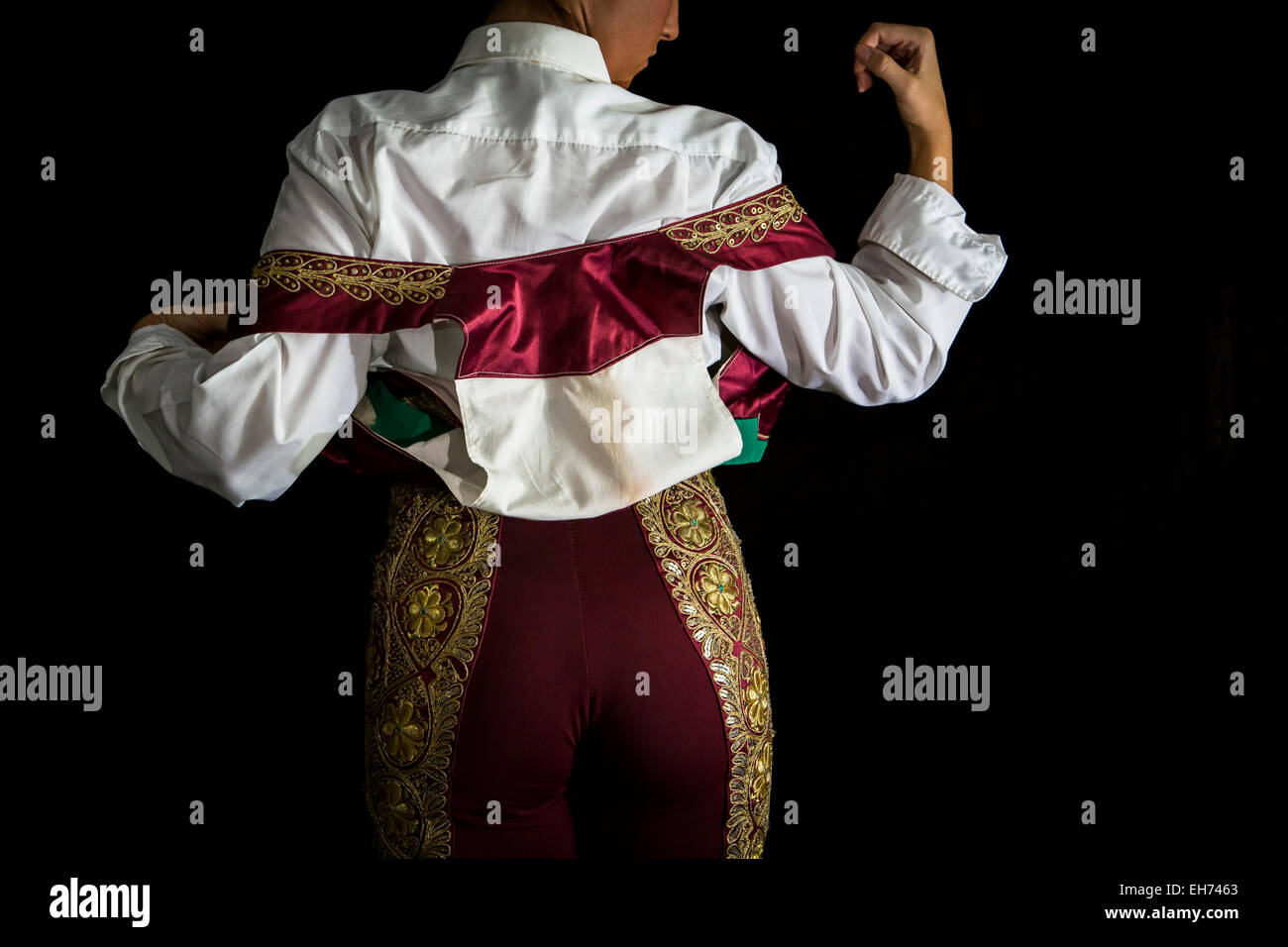 Woman bullfighter by dressing with vest on your back on a black ...
