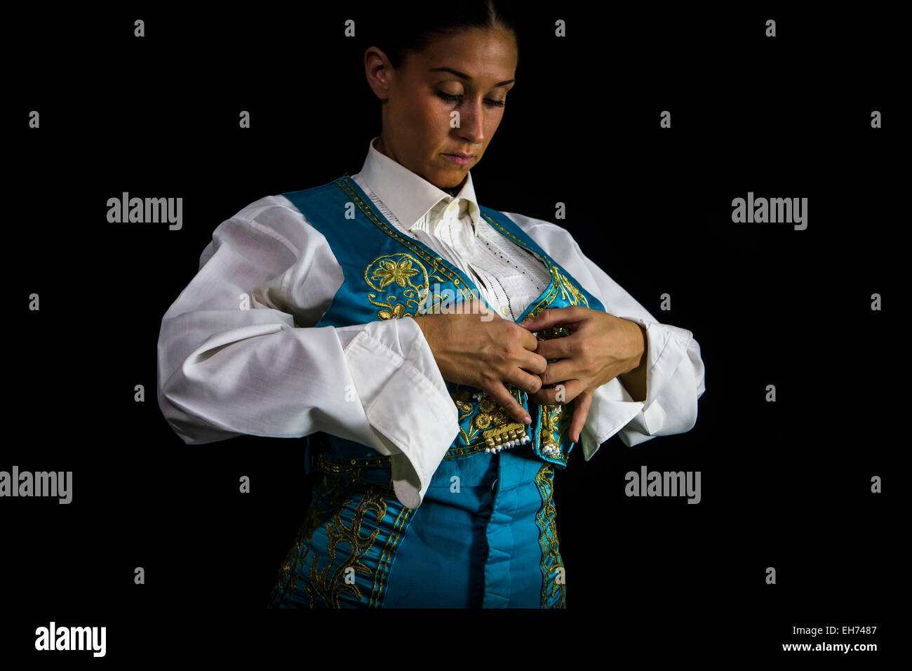 Woman bullfighter by dressing with vest on your back on a black ...