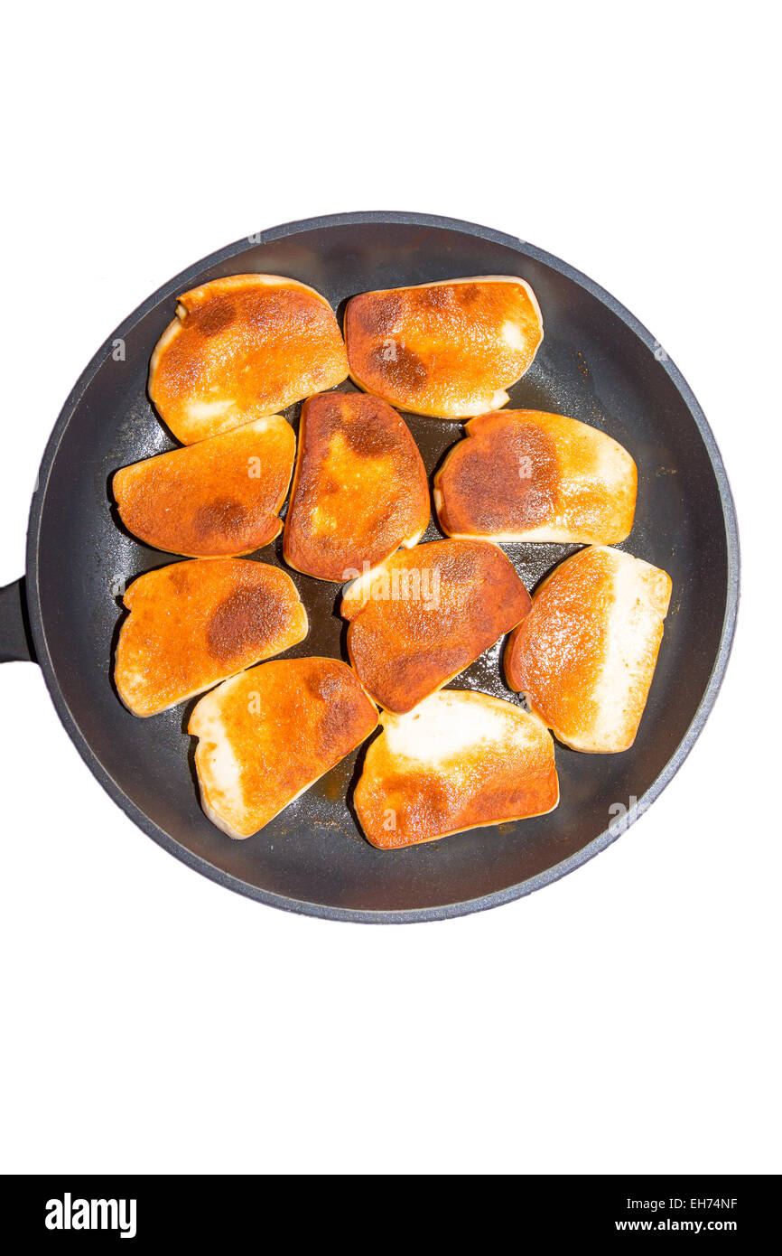 Picture of norwegian fish pudding slices in a frying pan Stock Photo ...