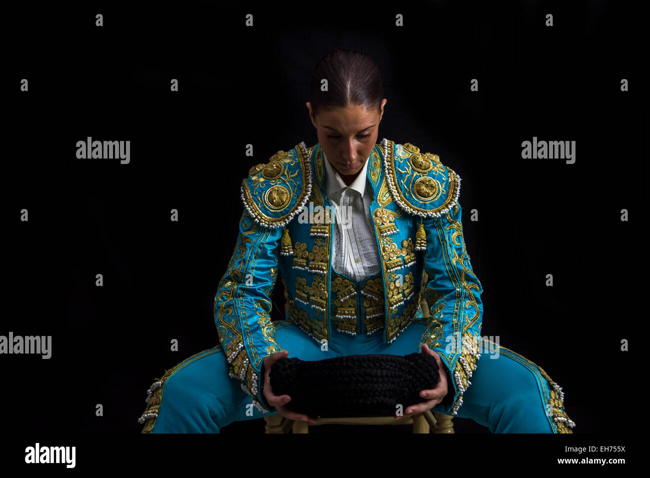 Woman bullfighter sitting on a chair looking at his montera ...
