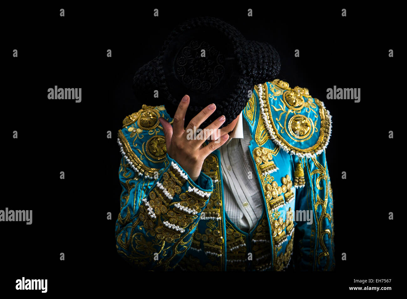Woman bullfighter salutes with his montera in black background Stock ...