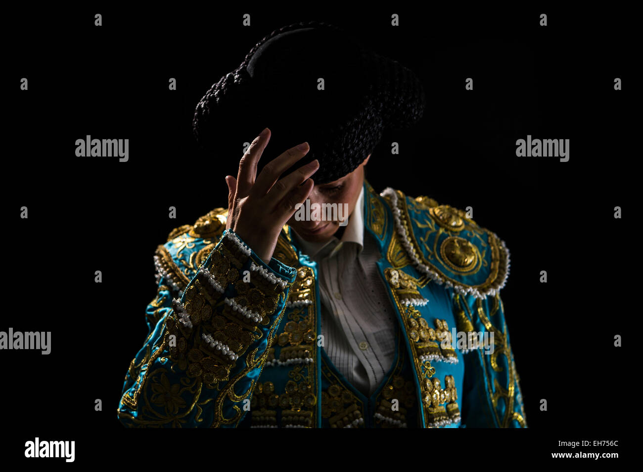 Woman bullfighter salutes with his montera in black background Stock ...