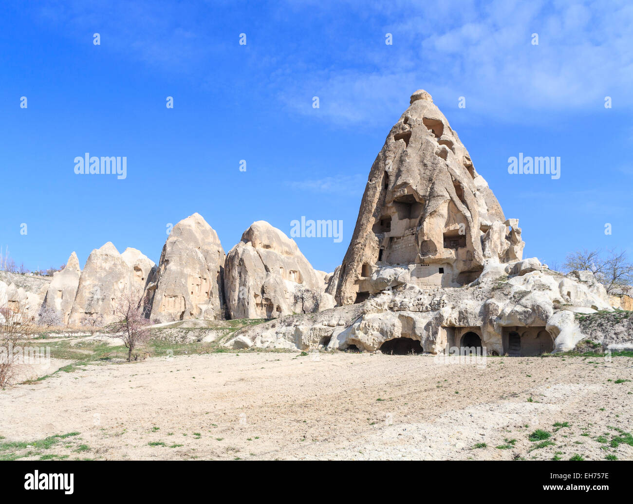 Fairy chimney rock formations with caves and remains of troglodyte ...