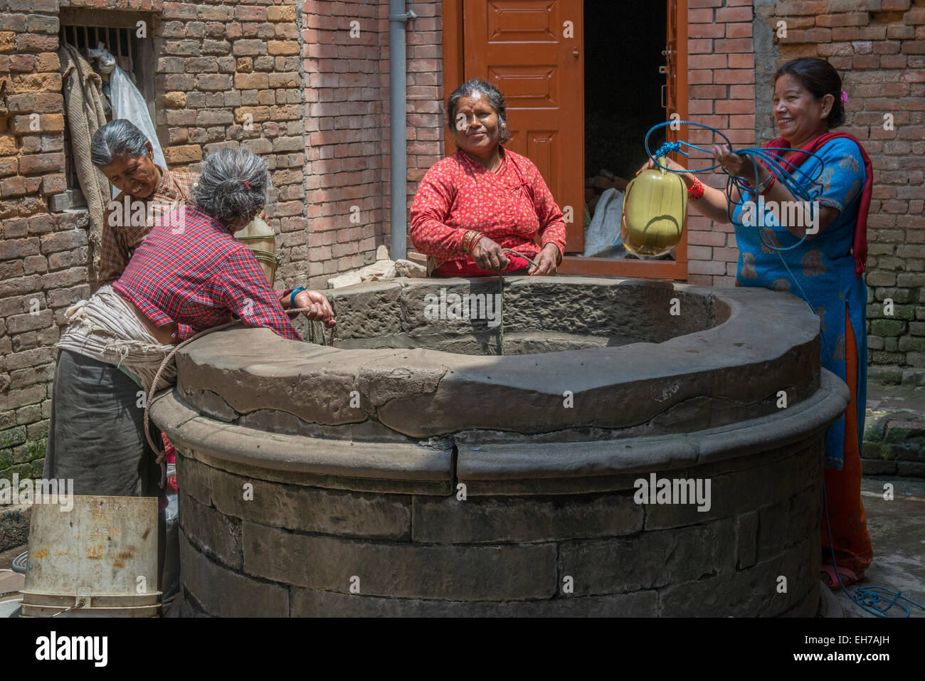 Women at well with water containers, Bhaktapur Stock Photo - Alamy