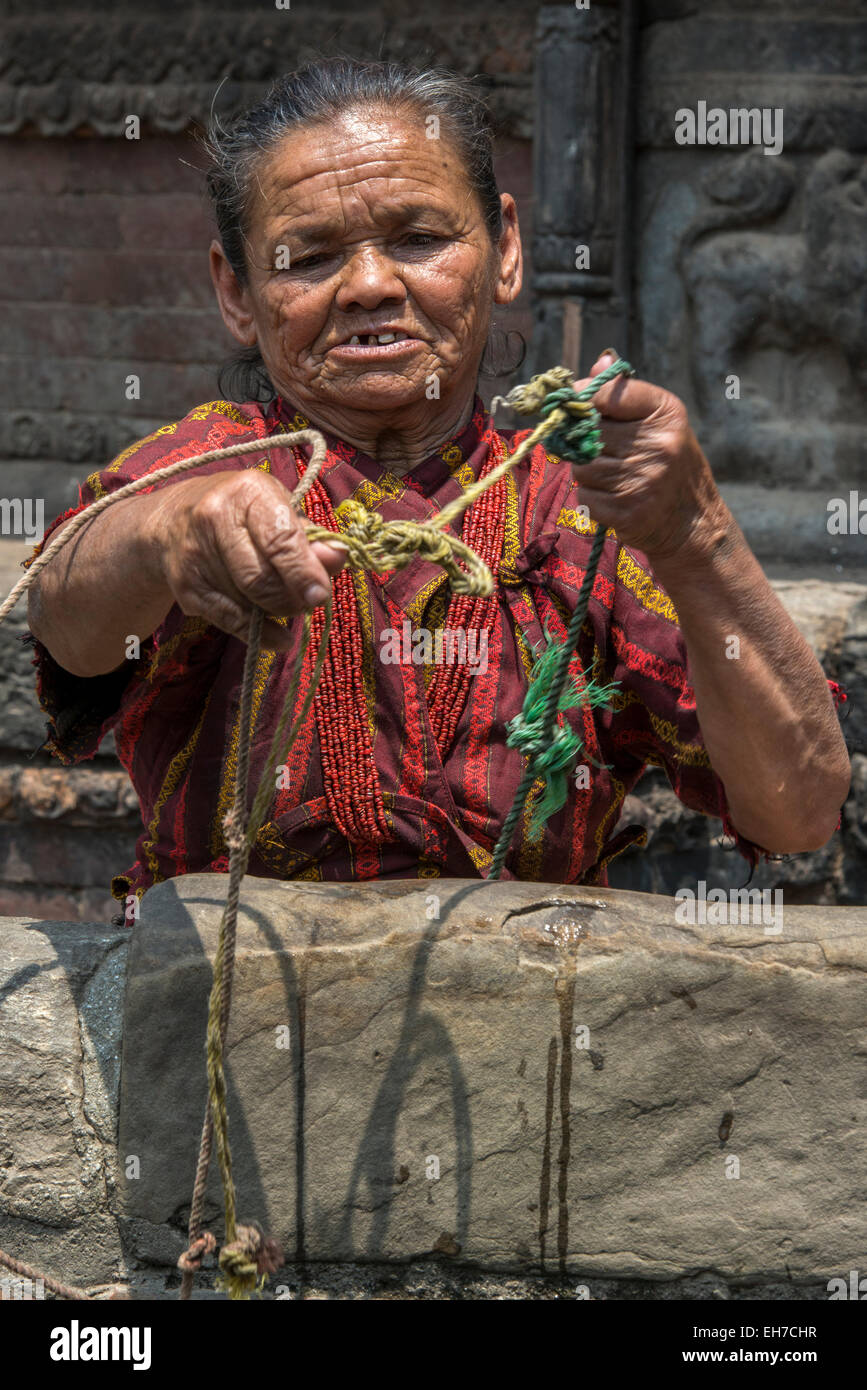 Woman getting water well hi-res stock photography and images - Alamy