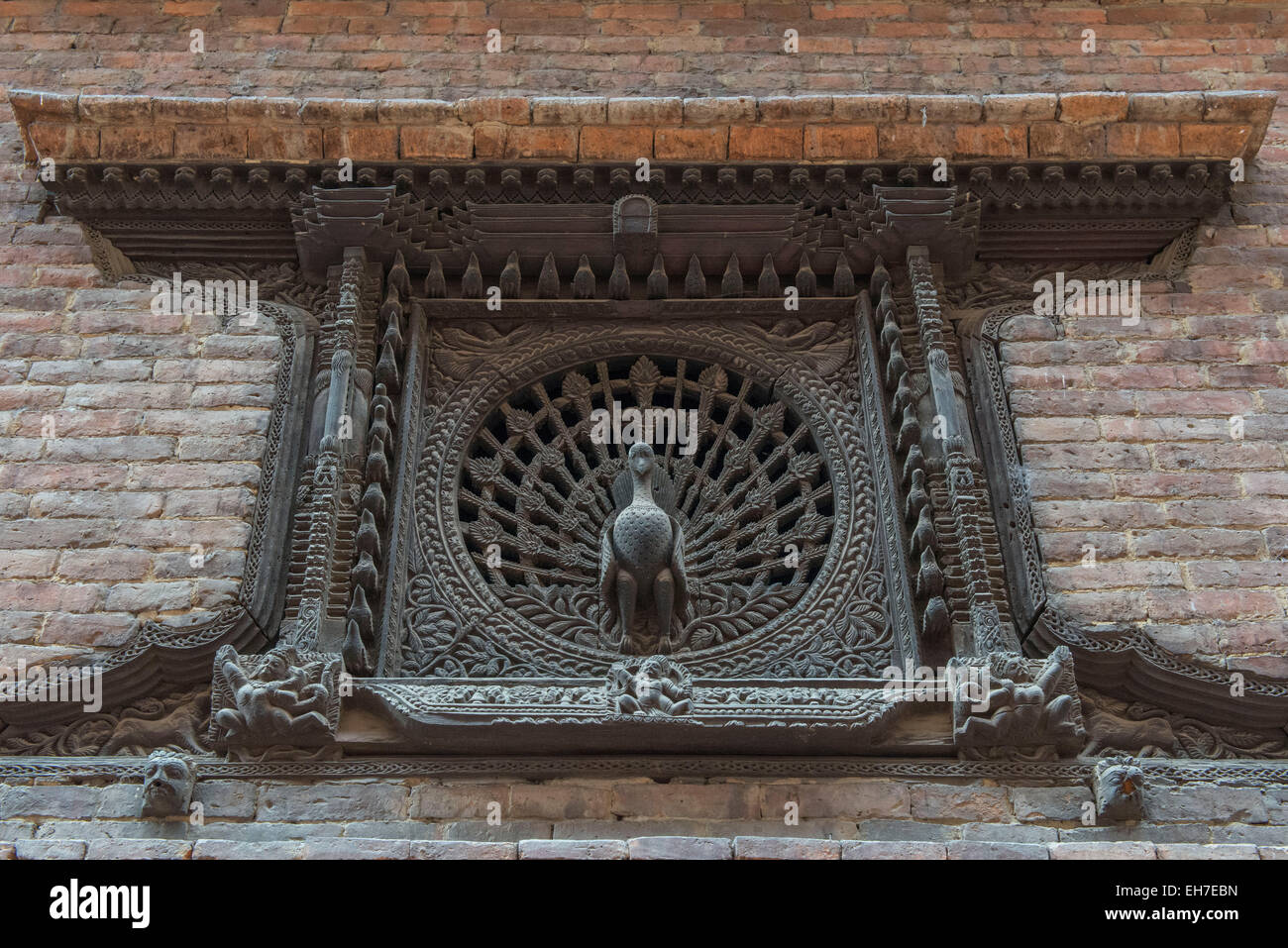 Carved wood opening on brick wall, Bhaktapur Stock Photo - Alamy