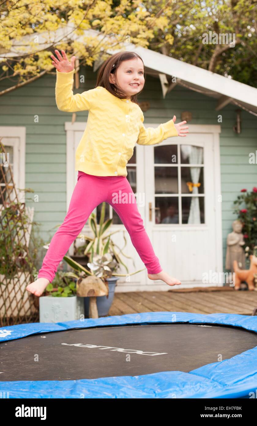 Girl bouncing on a trampoline Stock Photo - Alamy