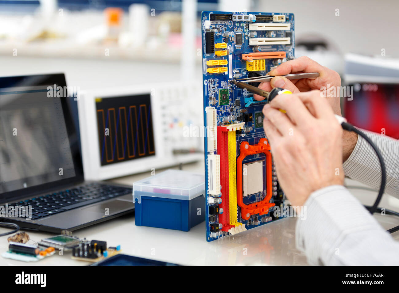 Person repairing electronic circuit board Stock Photo - Alamy