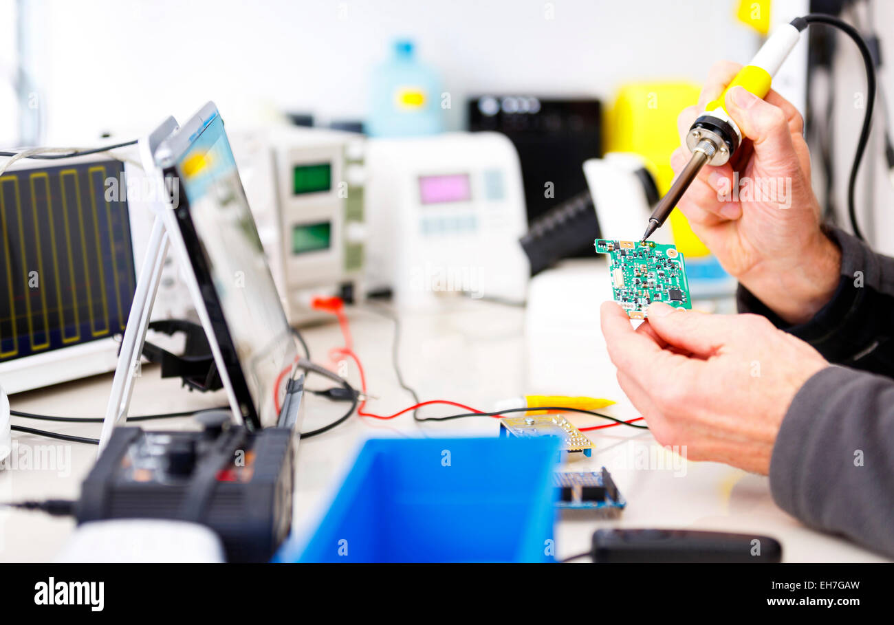 Person repairing electronic circuit board Stock Photo - Alamy