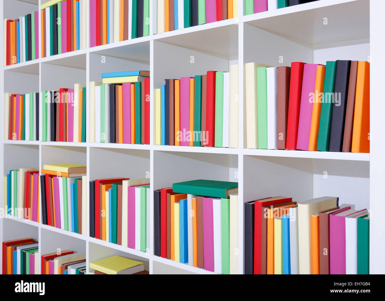 Colourful books on a bookcase Stock Photo - Alamy