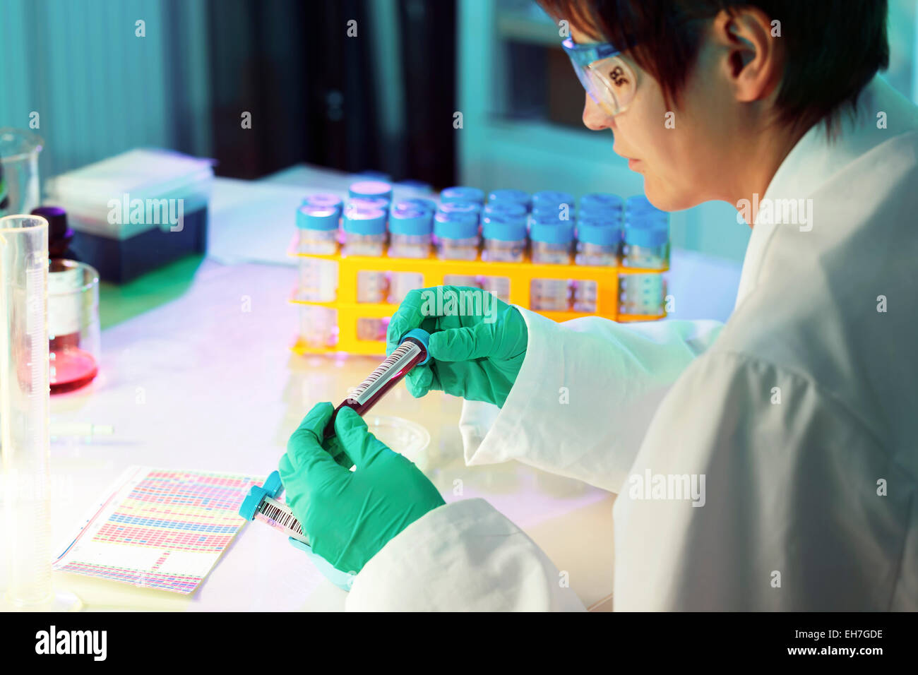 Lab technician holding test tube Stock Photo - Alamy