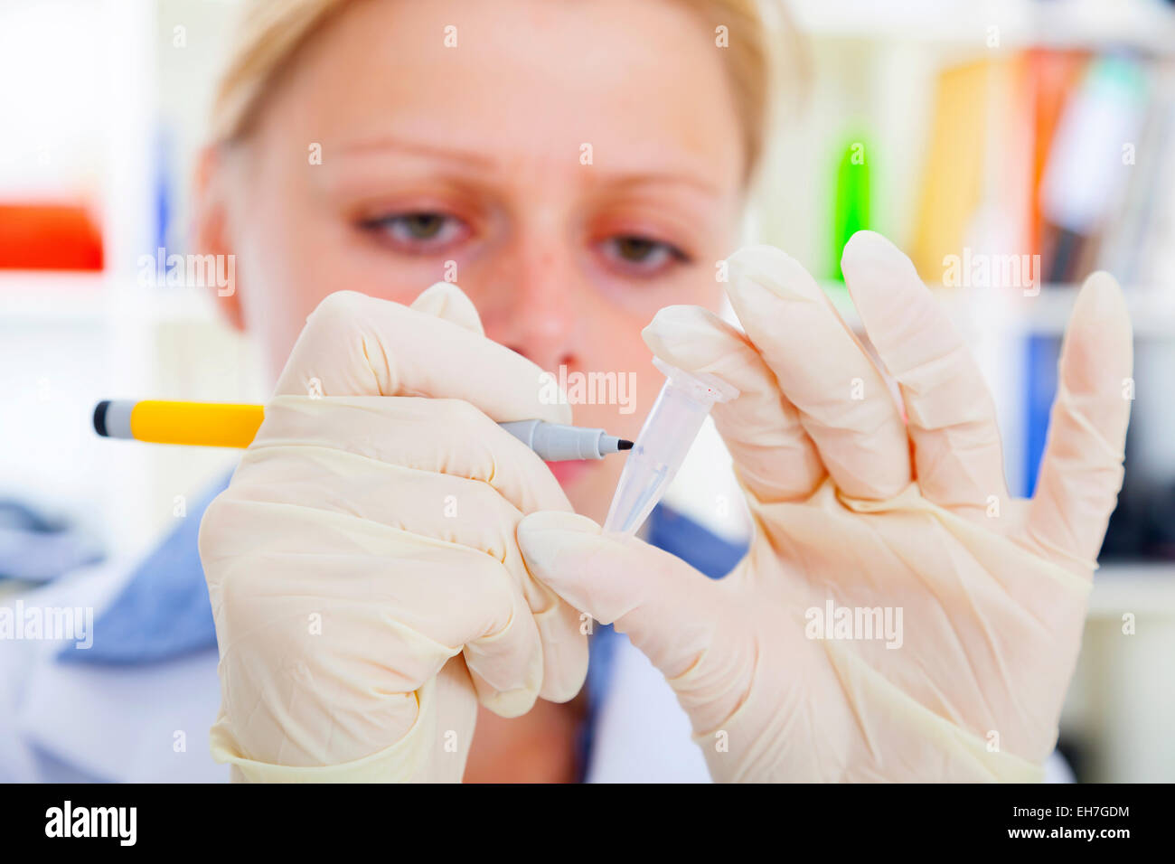 Lab technician writing on test tube Stock Photo - Alamy