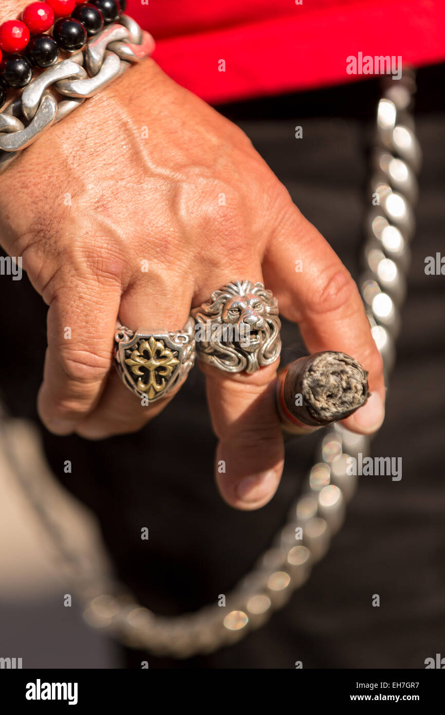 A biker wearing rings and holding a cigar during the 74th Annual ...
