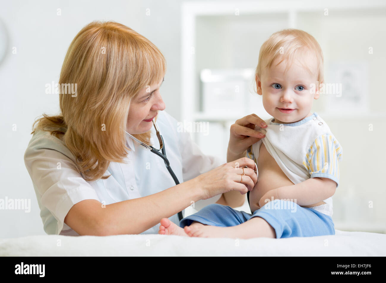 doctor woman examining heartbeat of kid boy with stethoscope Stock ...