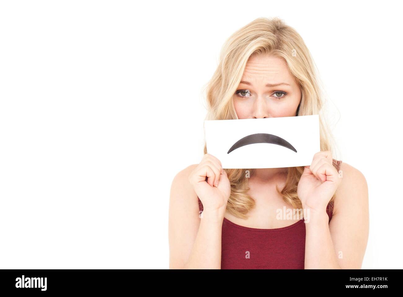 Woman holding sad mouth Stock Photo - Alamy