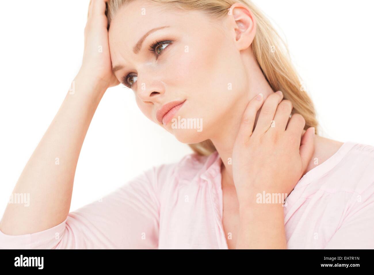 Woman with hand on neck Stock Photo - Alamy