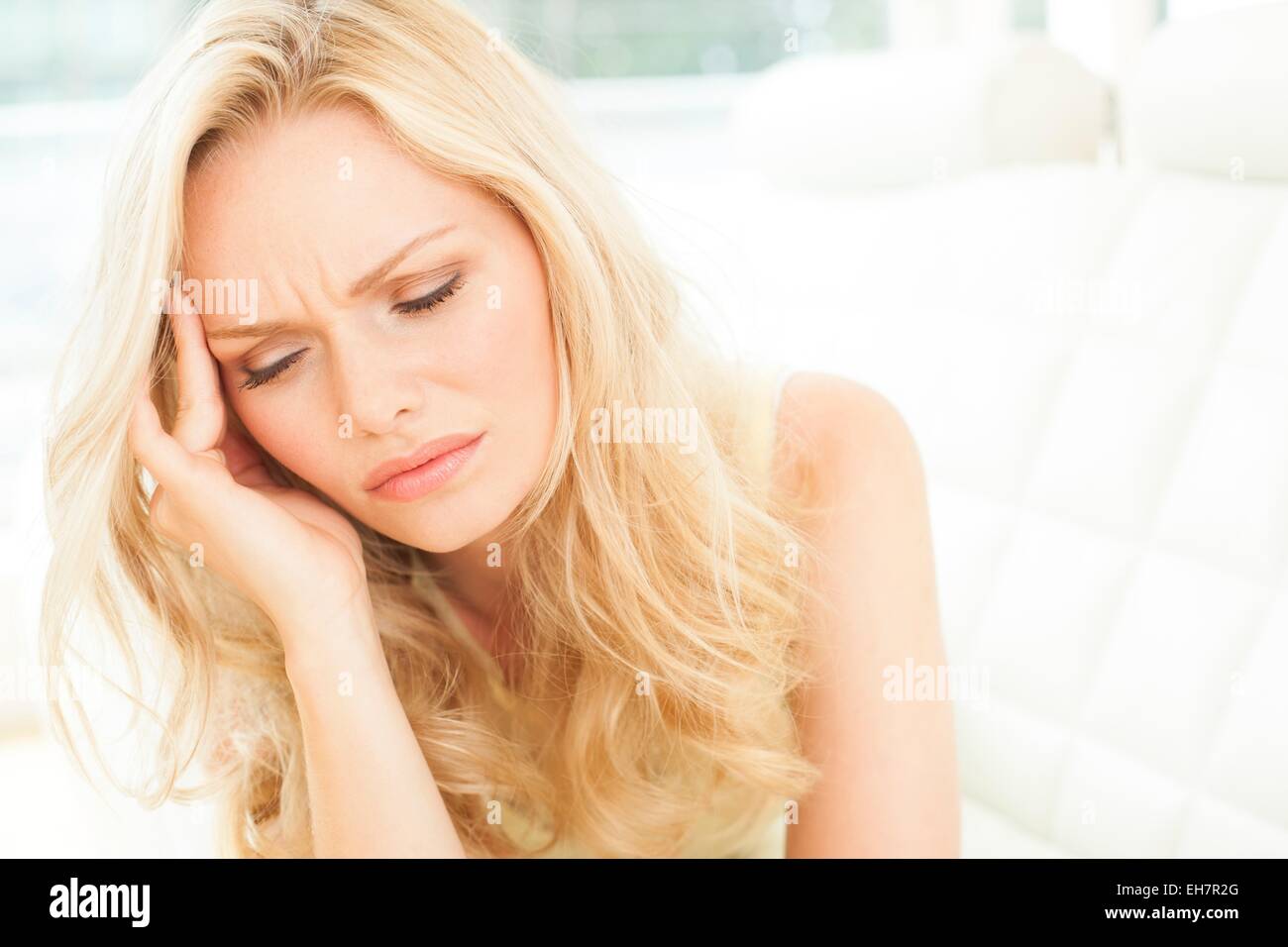 Woman touching head Stock Photo - Alamy
