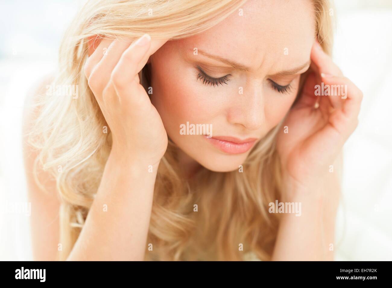 Woman touching head Stock Photo - Alamy