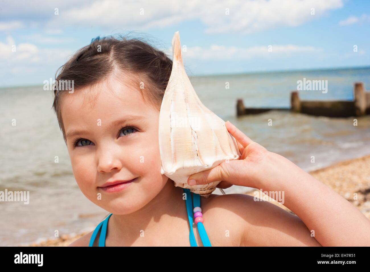Girl with seashell Stock Photo - Alamy