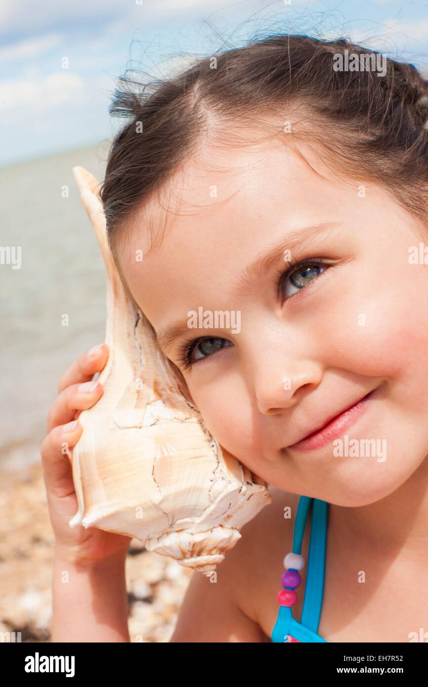 Girl with seashell Stock Photo - Alamy