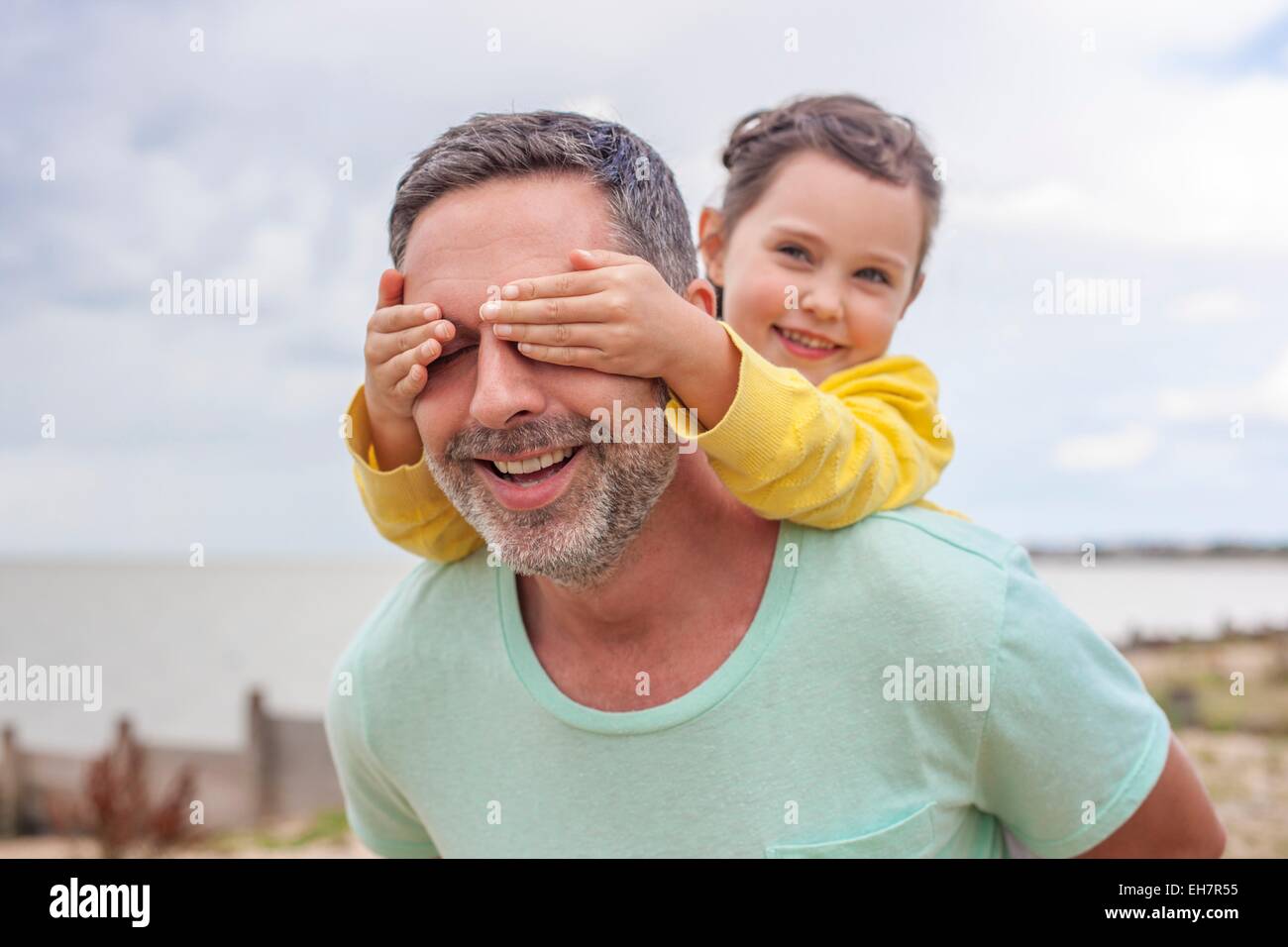 Daughter covering father's eyes Stock Photo - Alamy