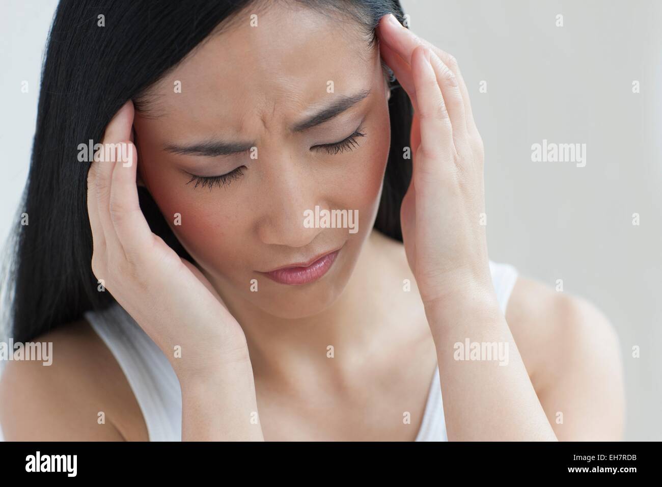 Woman touching head Stock Photo - Alamy