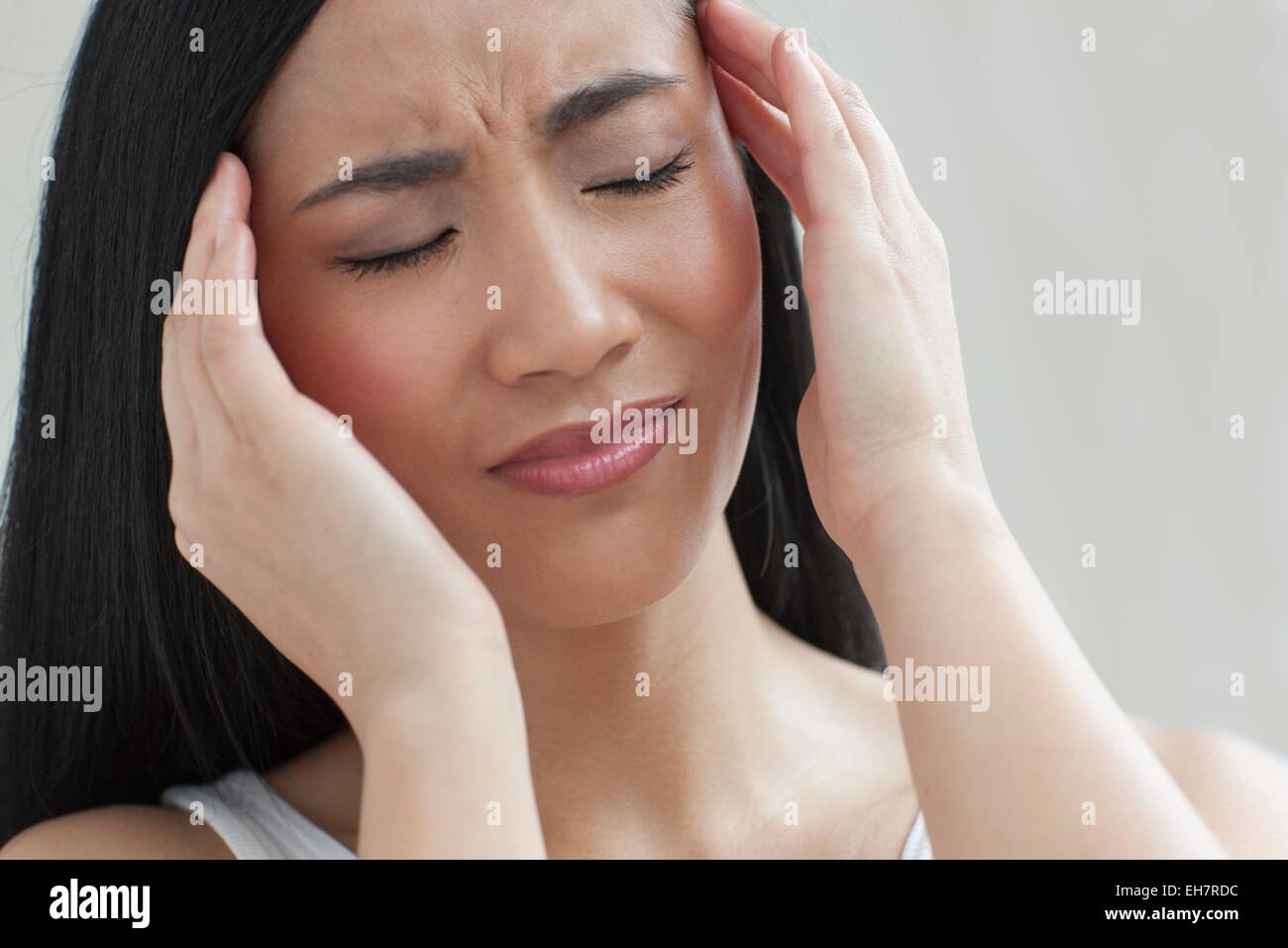 Woman touching head Stock Photo - Alamy