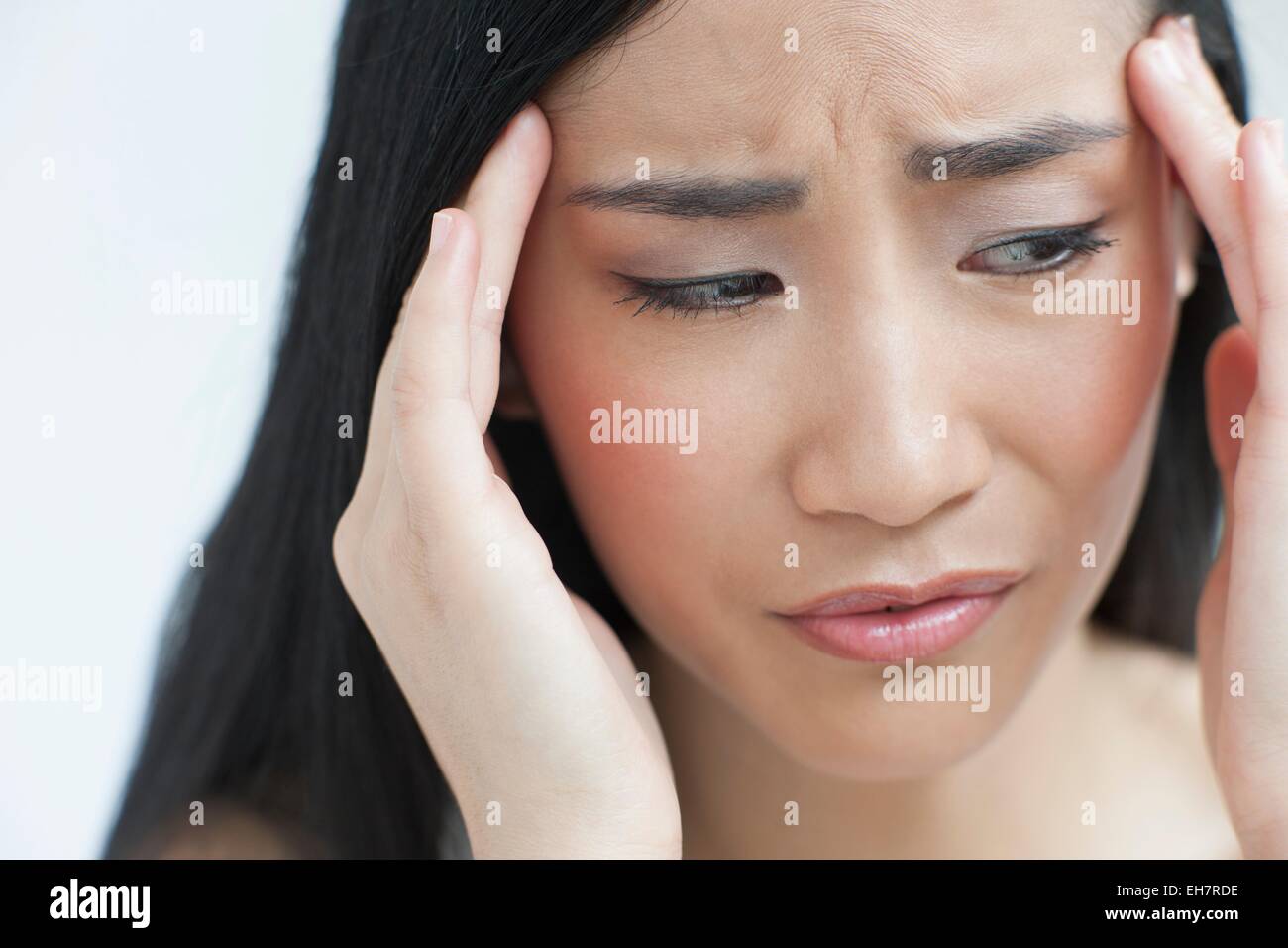 Woman touching head Stock Photo - Alamy