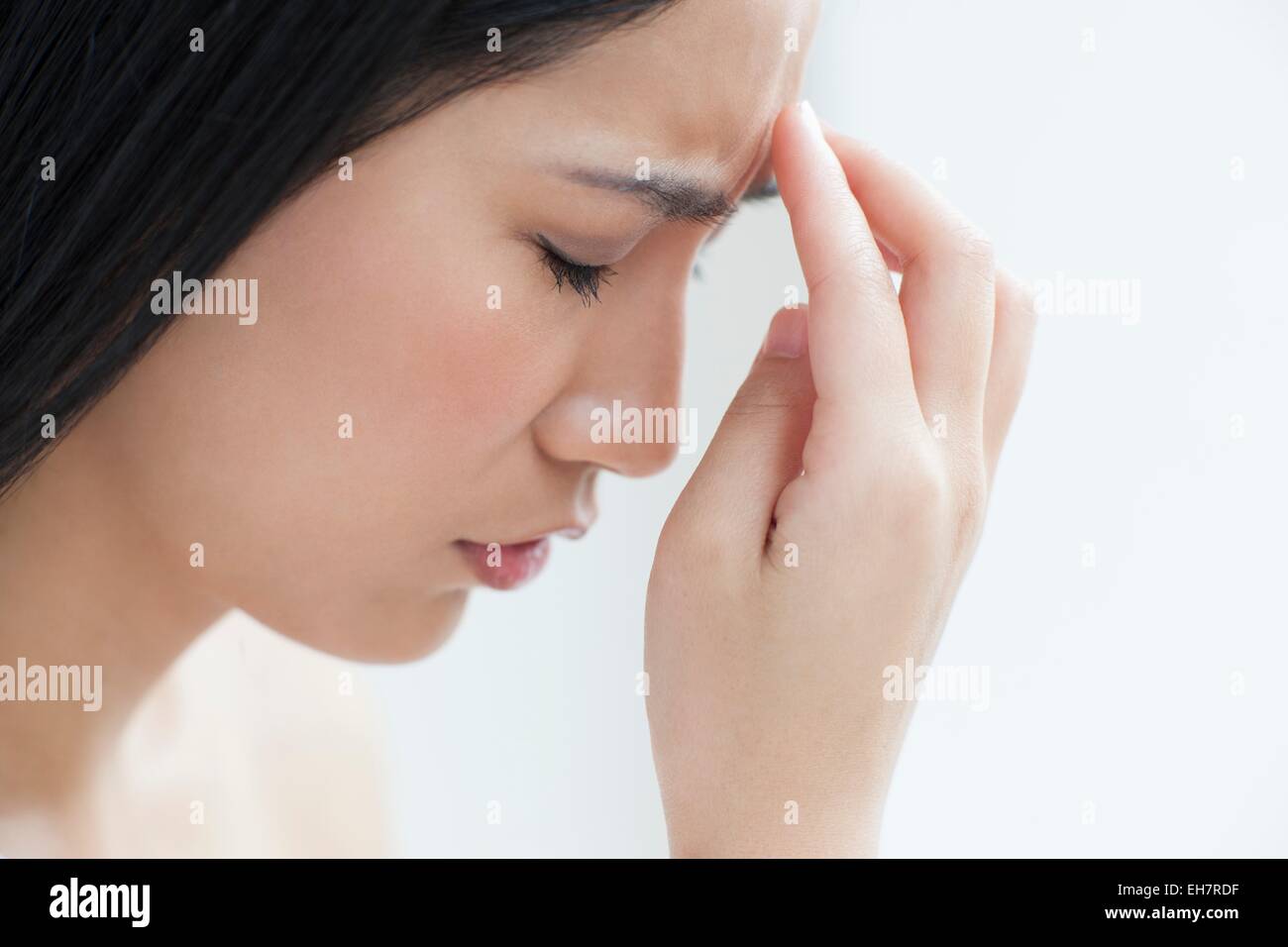 Woman touching head Stock Photo - Alamy