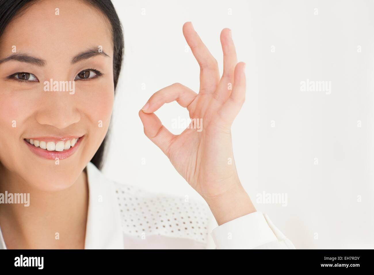 Woman making ok sign Stock Photo - Alamy