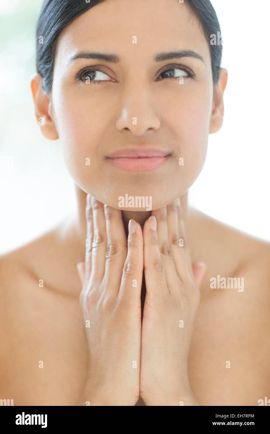 Woman touching her neck Stock Photo - Alamy