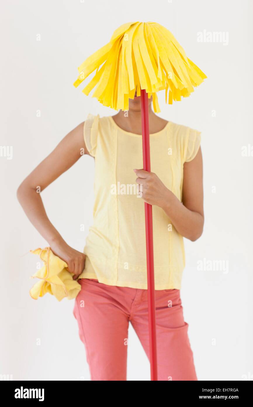 Woman holding mop in front of face Stock Photo - Alamy