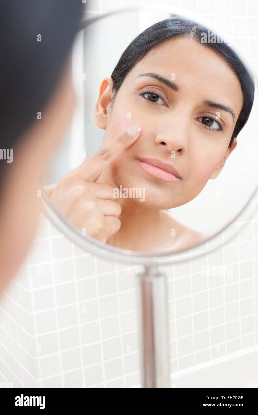 Woman applying face cream Stock Photo - Alamy