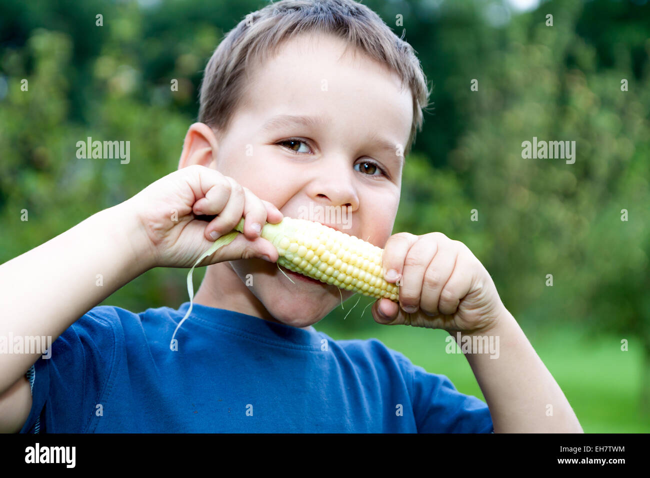 boy eating young corn outdoors Stock Photo - Alamy