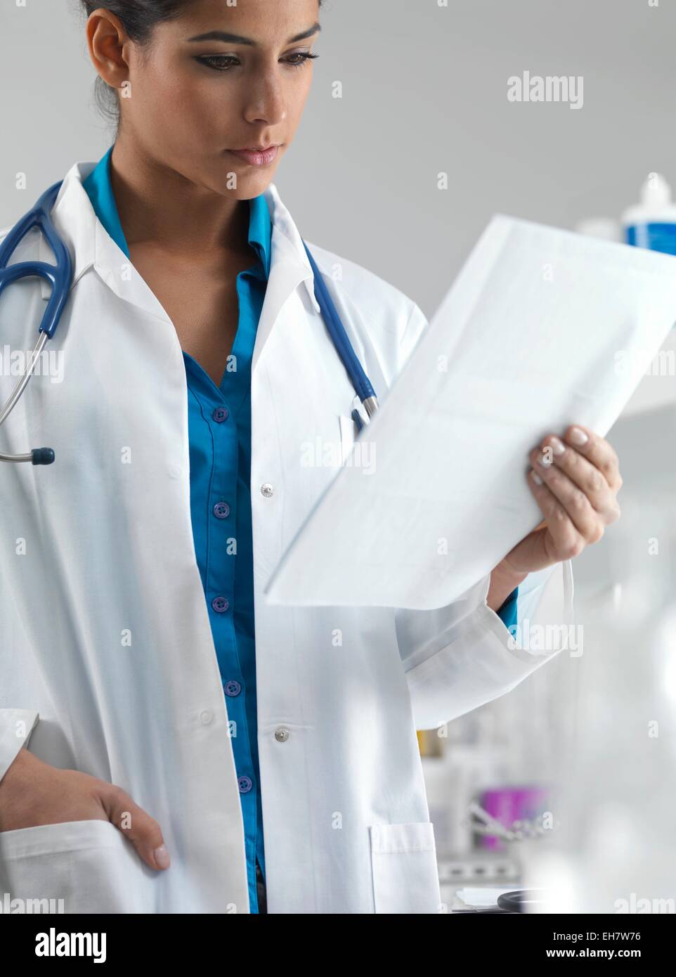 Doctor reading a patient's notes Stock Photo - Alamy