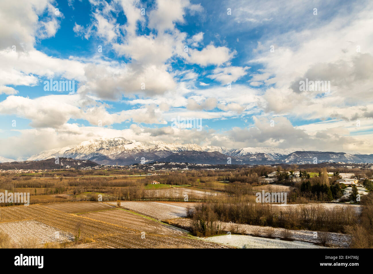 a light snowfall on the italian countryside, with white fields and ...