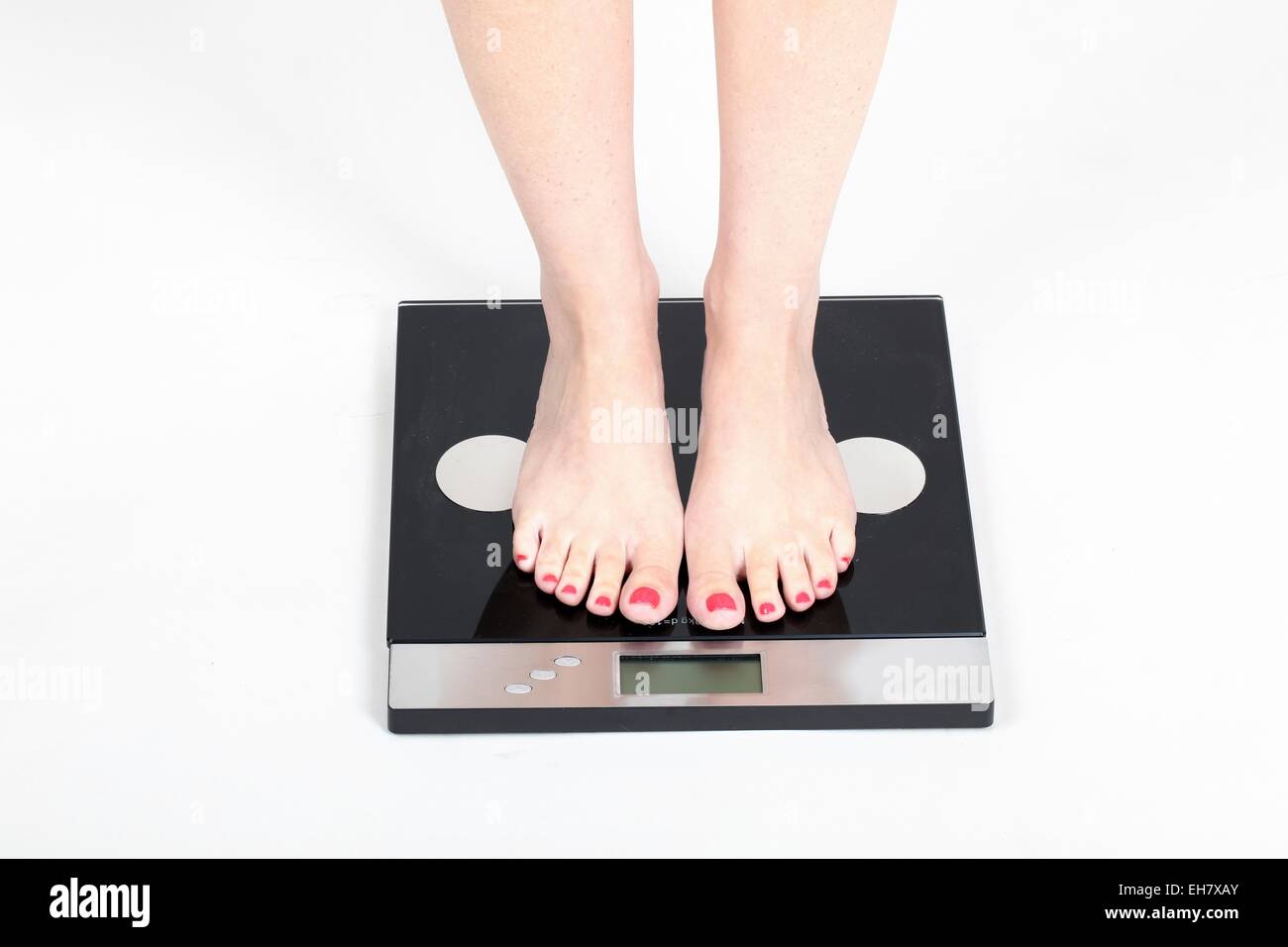 Woman's feet on scale Stock Photo - Alamy