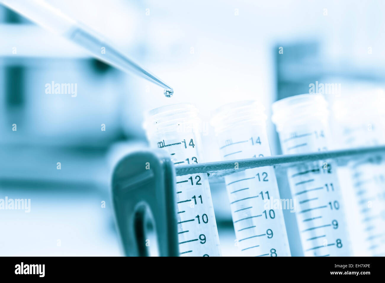 Pipette dropping liquid into test tubes Stock Photo - Alamy