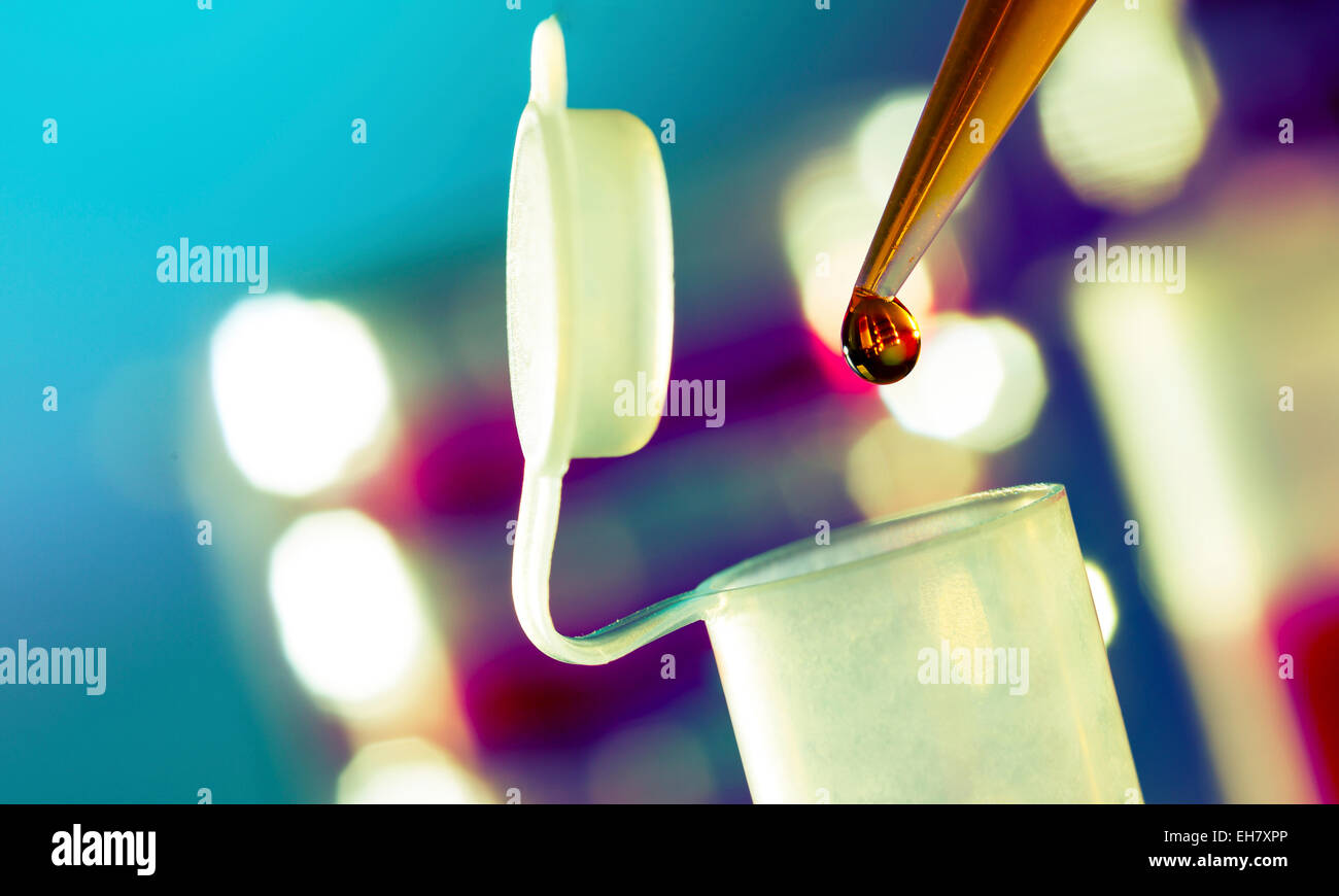 Pipette dropping liquid into micro tube Stock Photo - Alamy