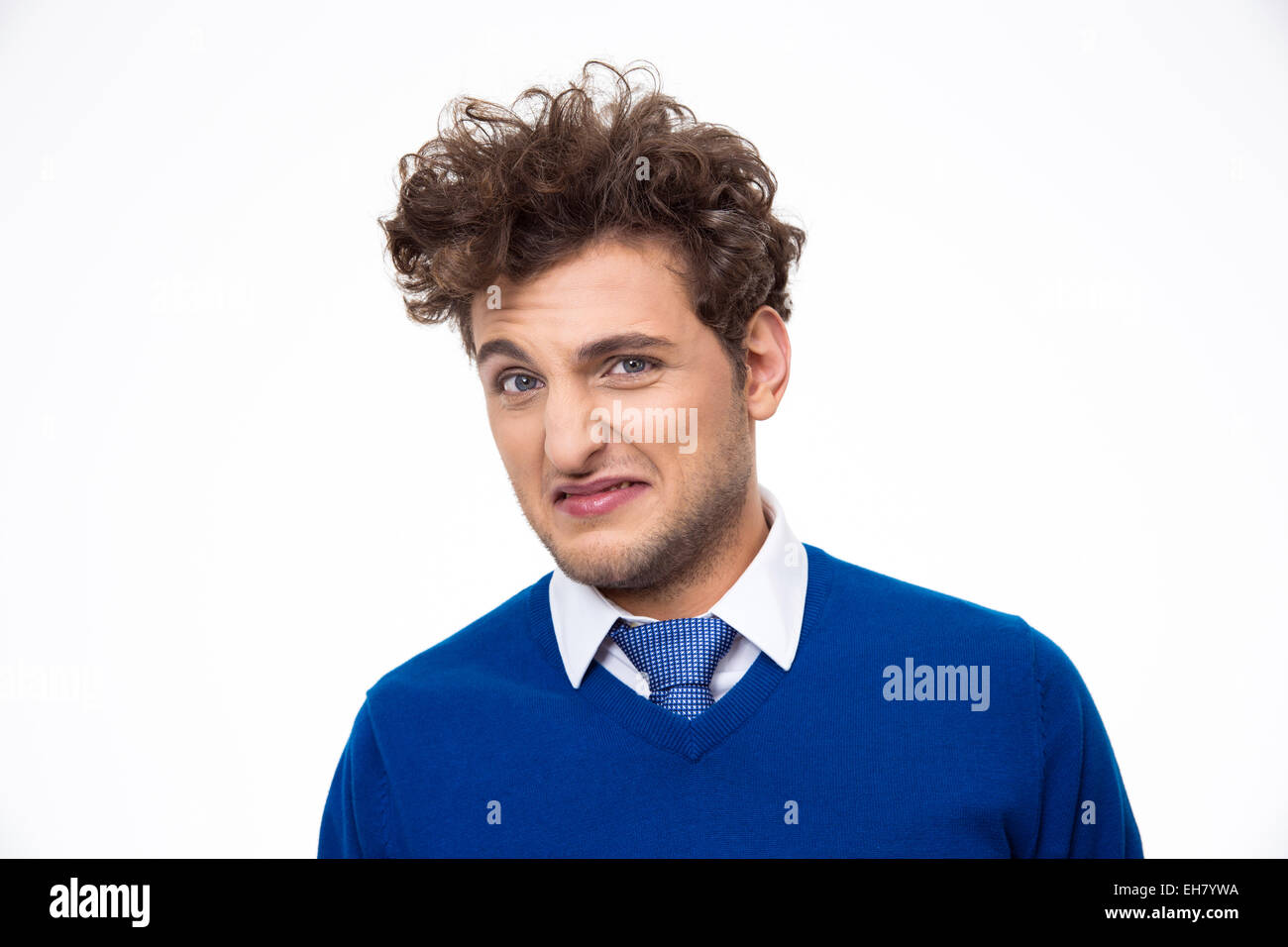 Young man expressing disgust over white background Stock Photo - Alamy
