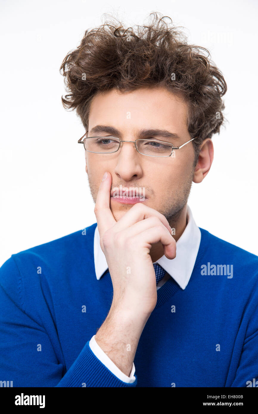 Pensive young businessman in glasses looking away Stock Photo - Alamy