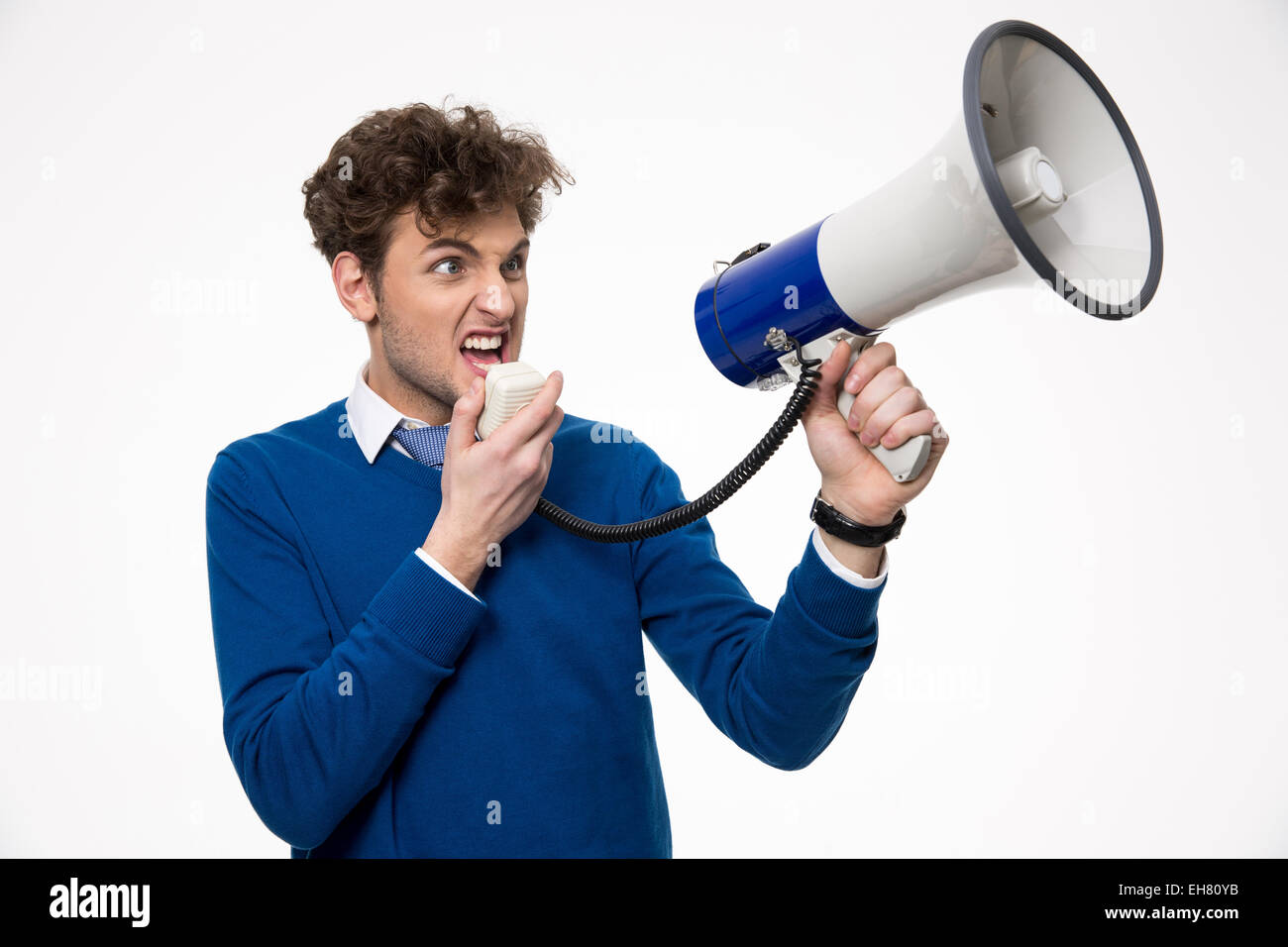 Man shouting through megaphone over gray background Stock Photo - Alamy