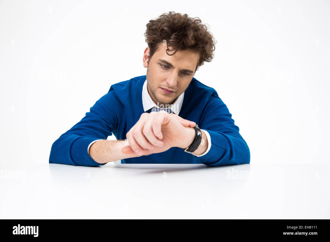 Handsome businessman looking at watch over white background Stock Photo ...