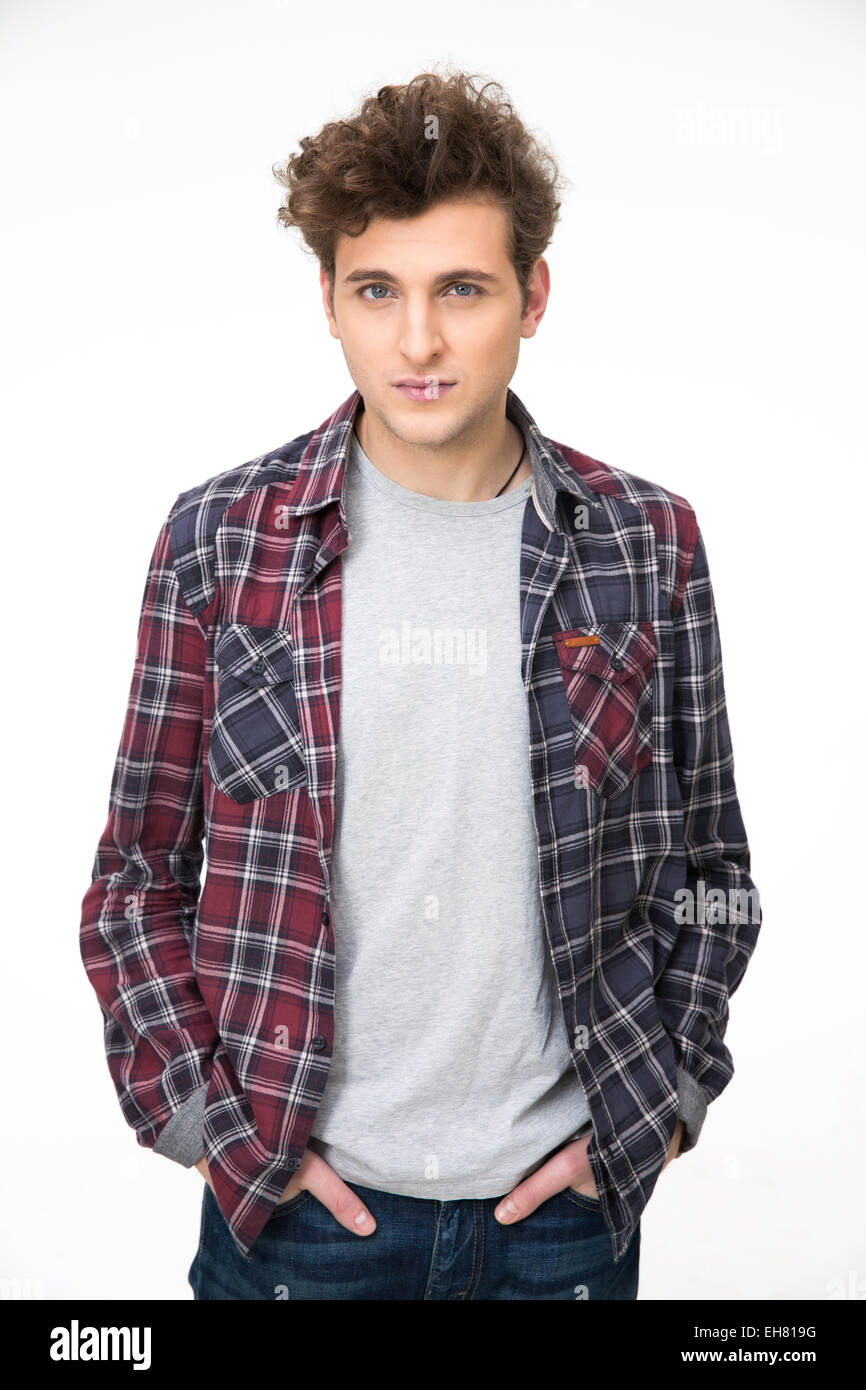 Young serious man standing over gray background Stock Photo - Alamy