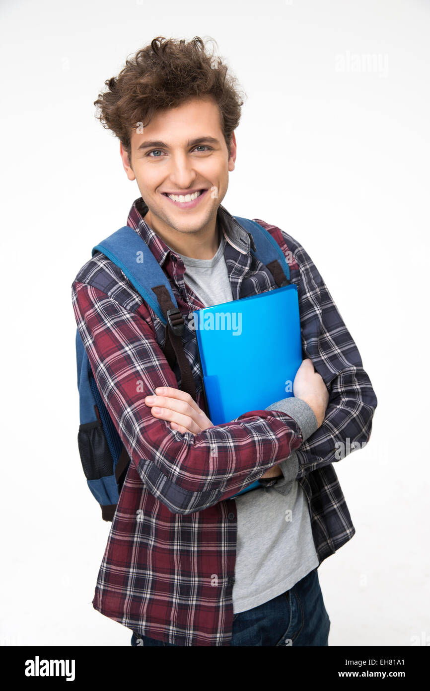 Smiling male student standing with folders over gray background Stock ...