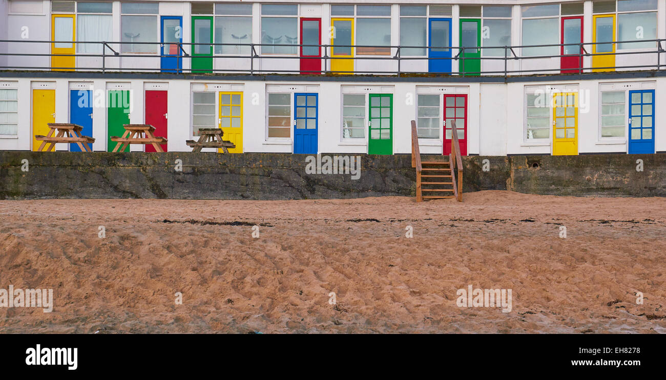 Traditional beach huts with bright painted doors Porthgwidden Beach St ...