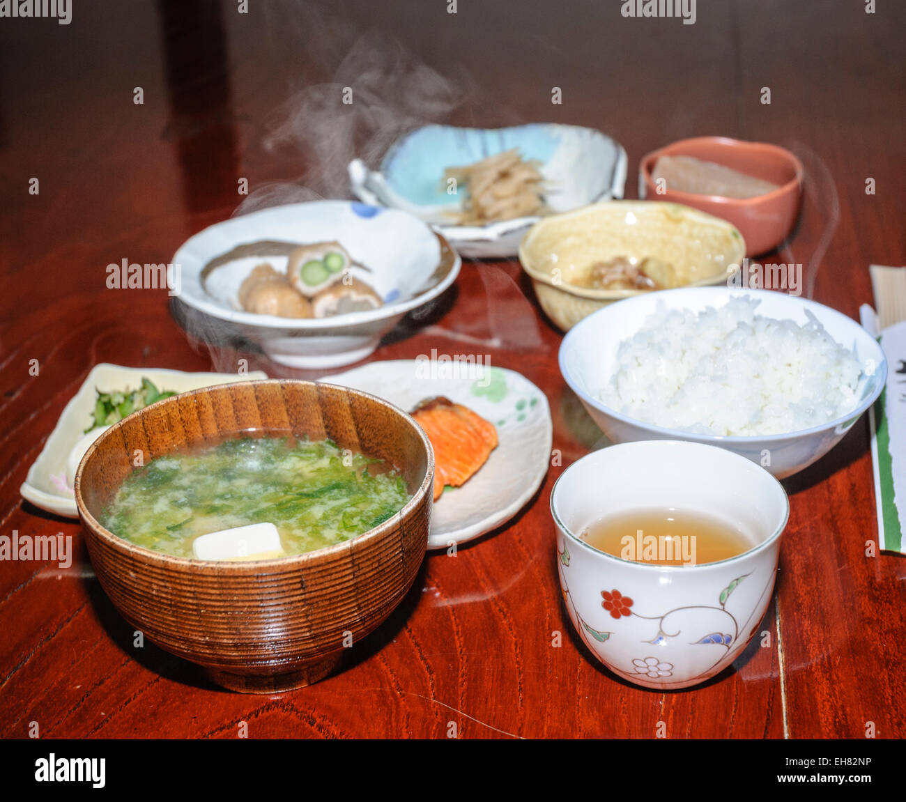 Steaming hot food in a traditional Japanese meal: several courses of ...